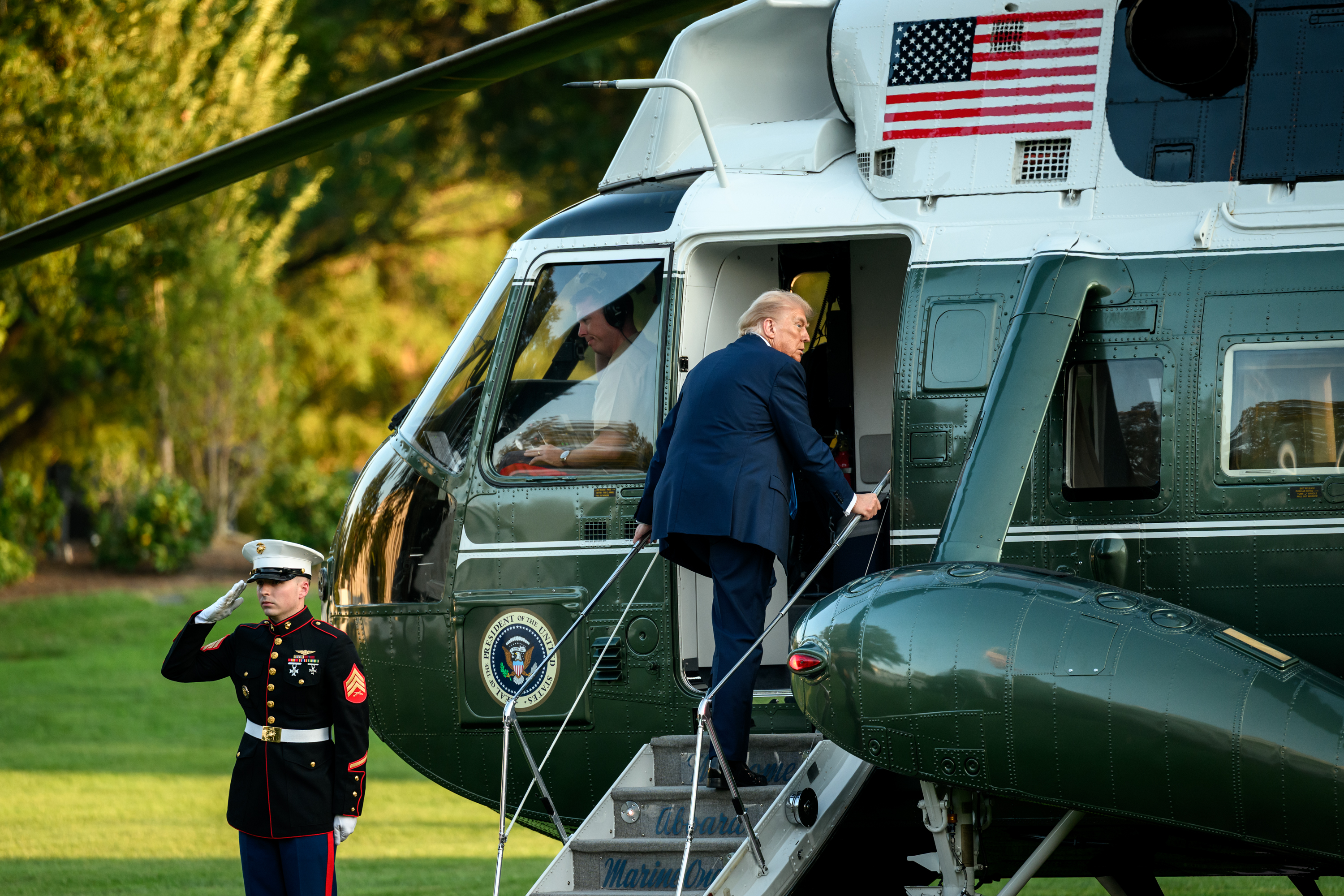 President Donald Trump boards Marine One on the South Lawn of the White ...
